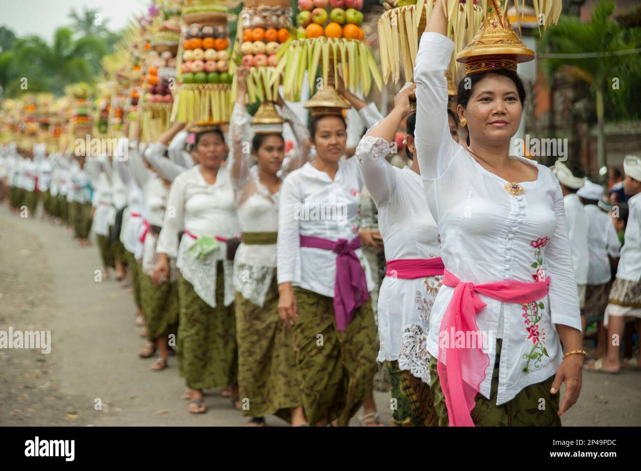 Women in procession carrying offerings during Mepeed ceremony, Siat ...