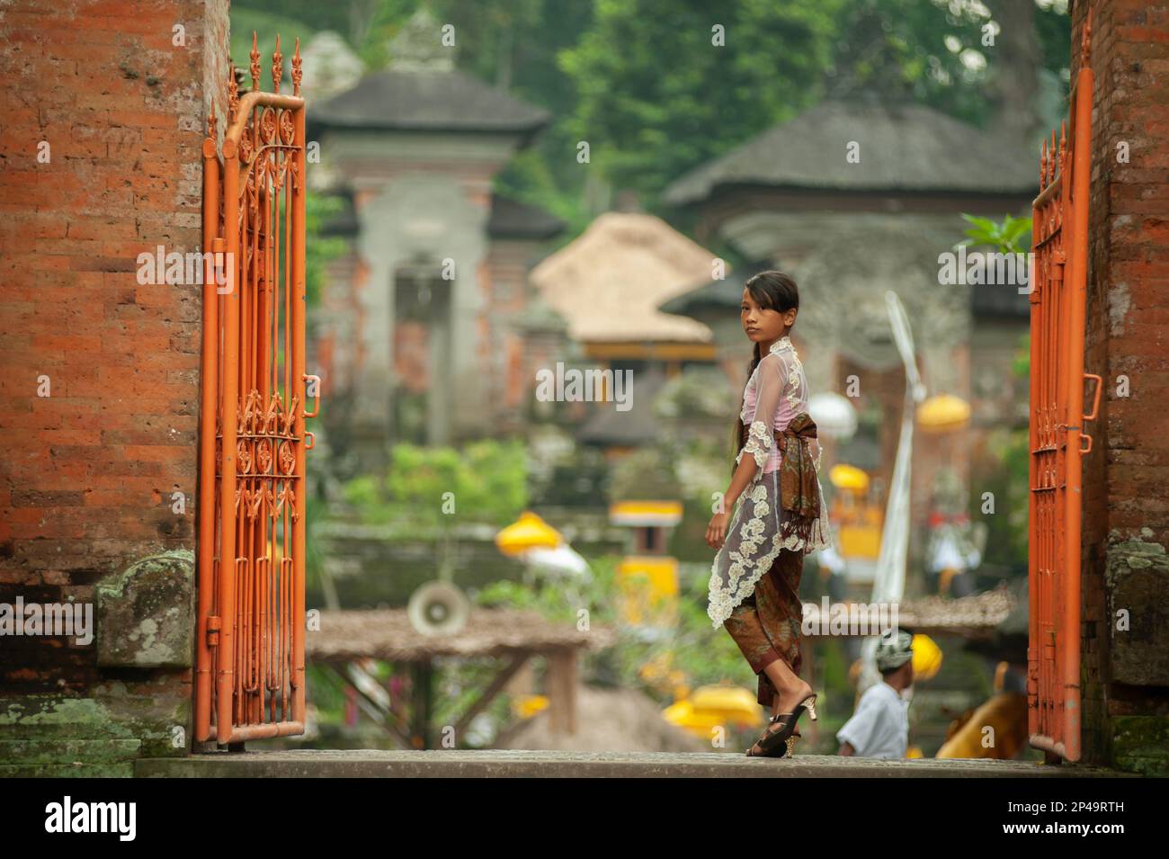 Girl in gateway, Siat Sampian (coconut leaf war) festival, Pura Samuan ...