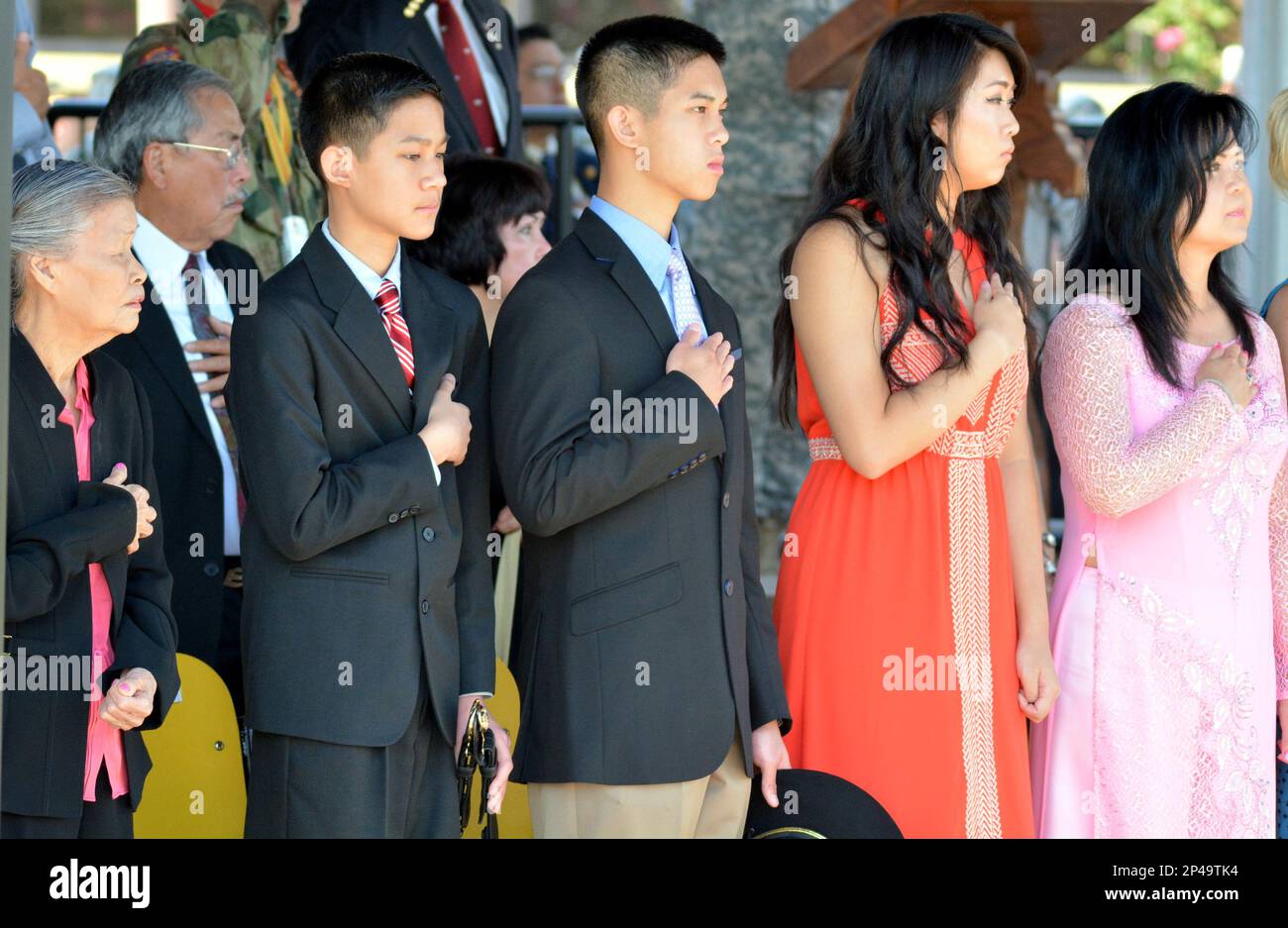 The family of Col. Viet Luong stand with hands over their hearts during ...
