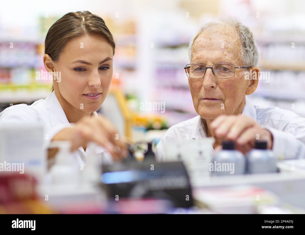 Helping clients make informed decisions. a young pharmacist helping an ...