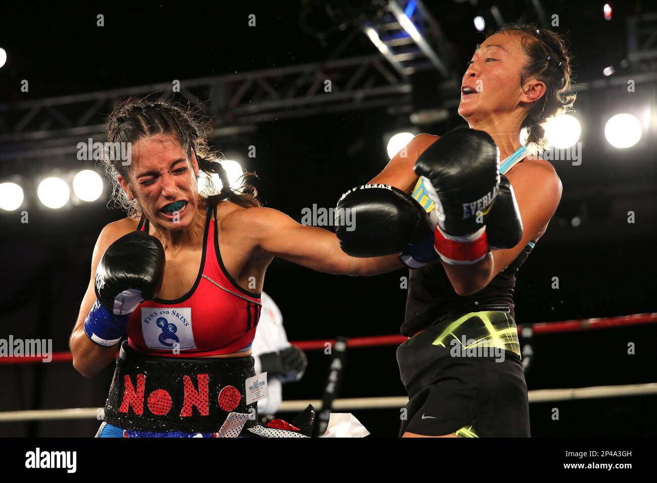 Noemi "NoNo" Bosques (red) and Yolaine LinDeLauf fight during a ...