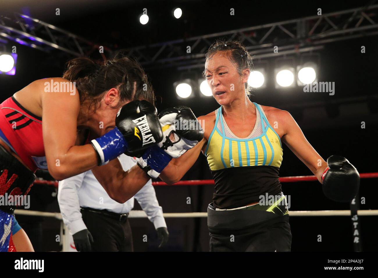 Noemi "NoNo" Bosques (red) and Yolaine LinDeLauf fight during a ...