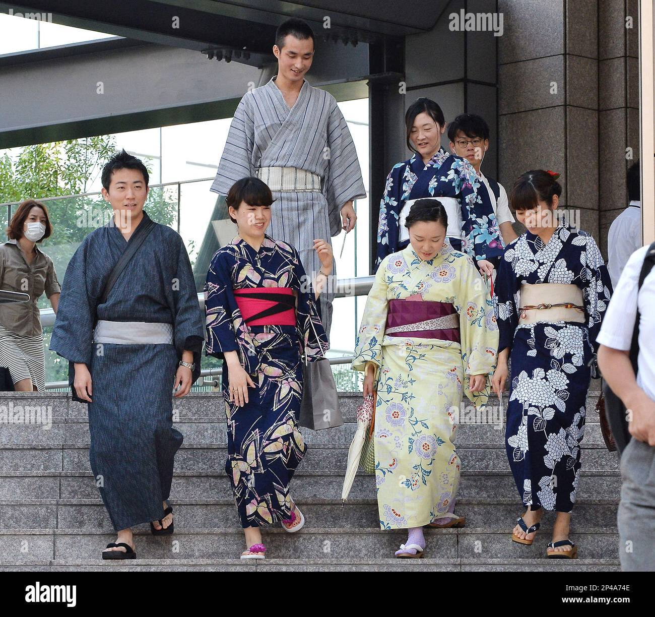 Women and men wearing yukata head to work in Shibuya Ward, Tokyo on ...