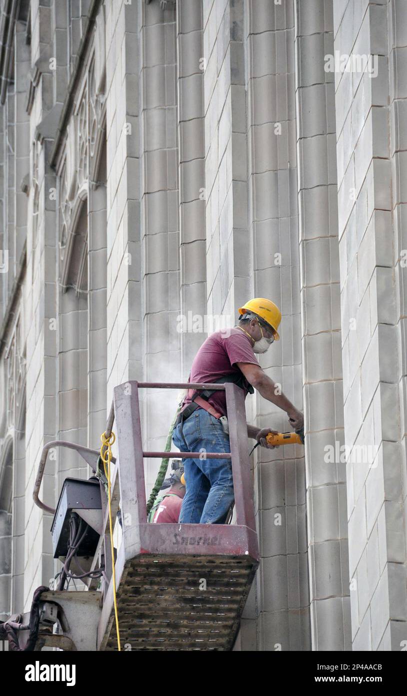 Workers from general contractor Quandel Material Deliveries sand the ...