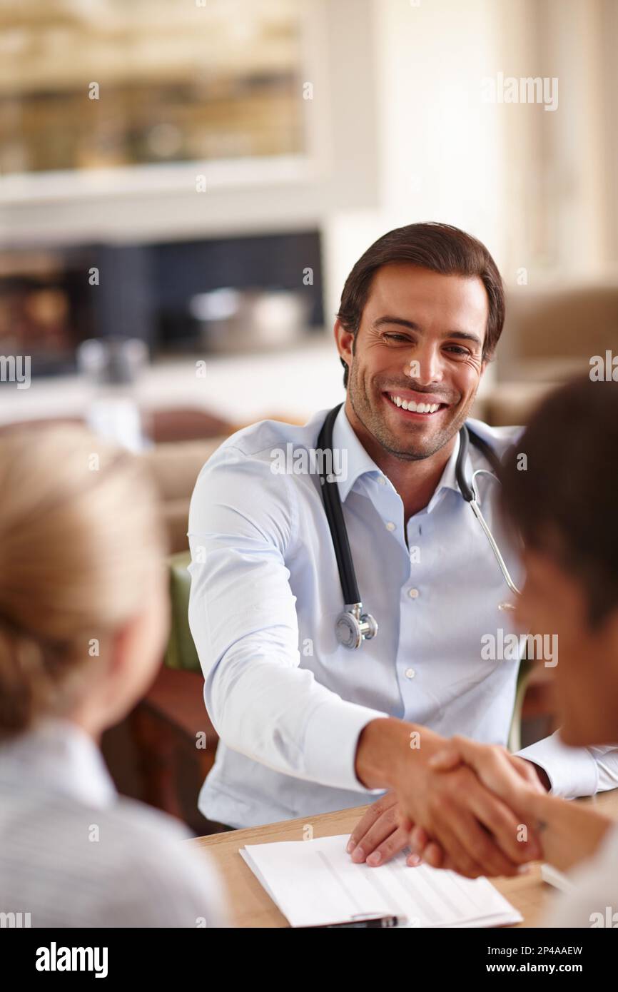Doctor congratulating couple hi-res stock photography and images - Alamy