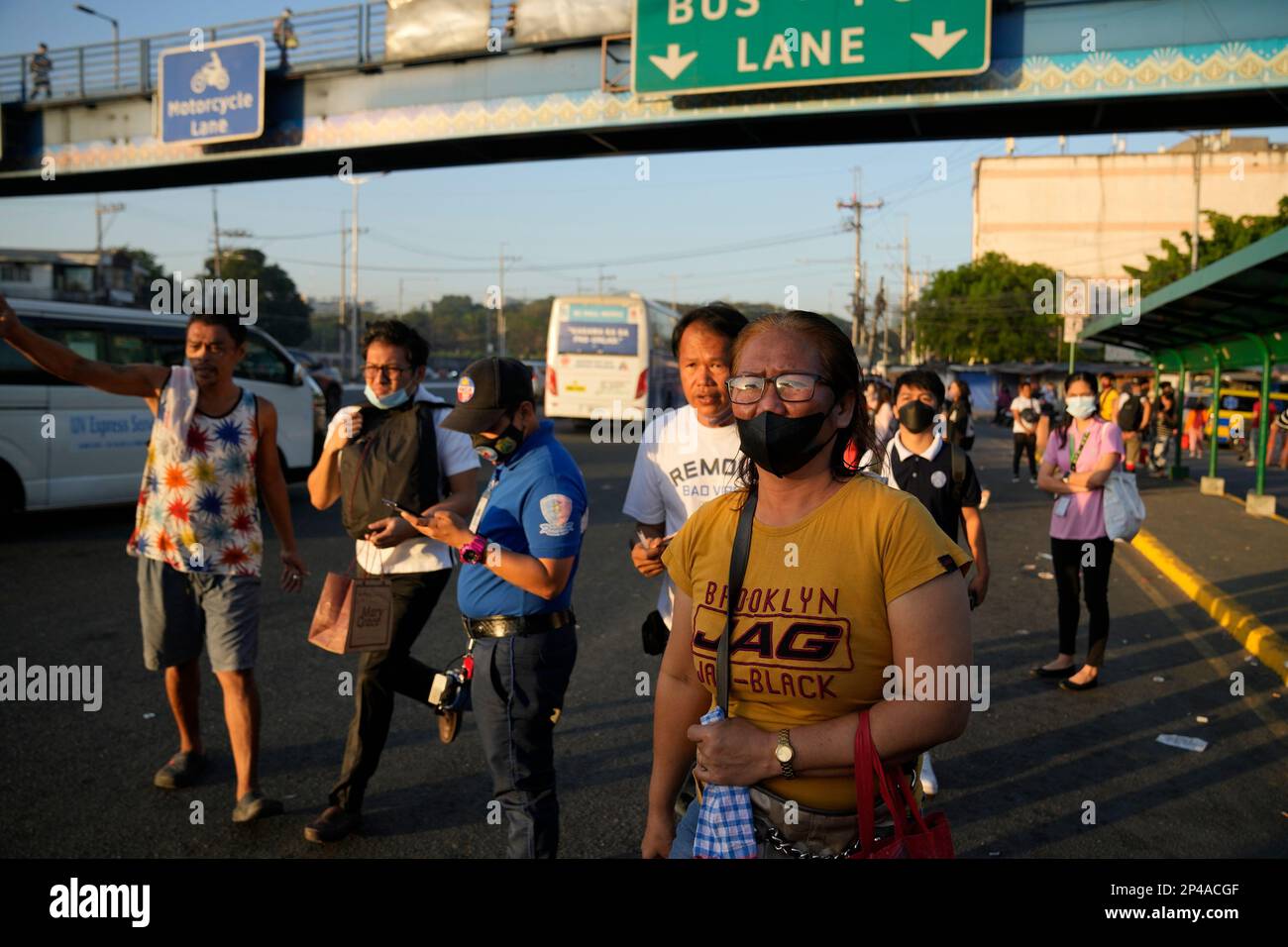 Commuters wait for a ride during a passenger jeepney strike in Quezon ...