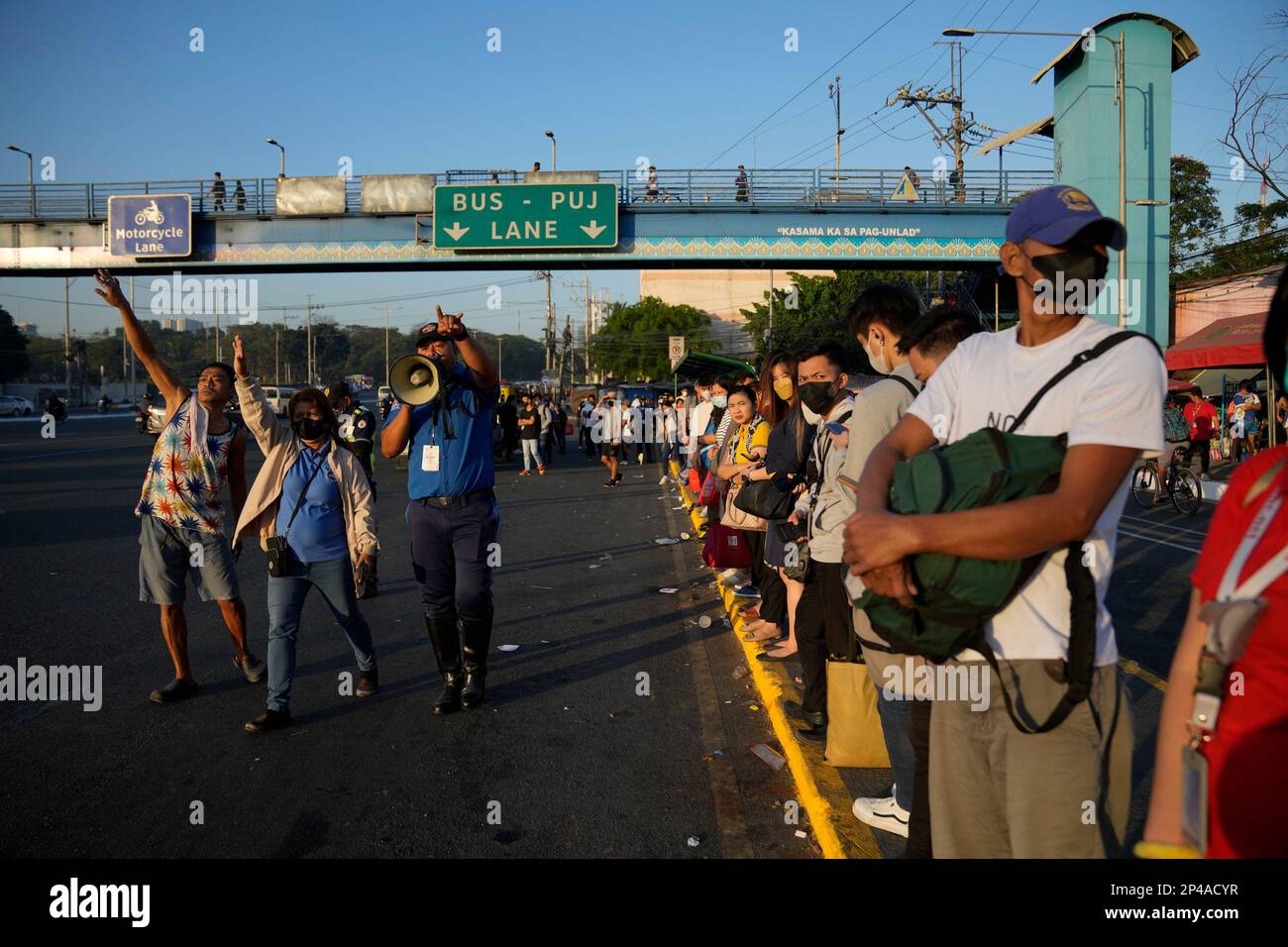 Commuters wait for a ride during a passenger jeepney strike in Quezon ...