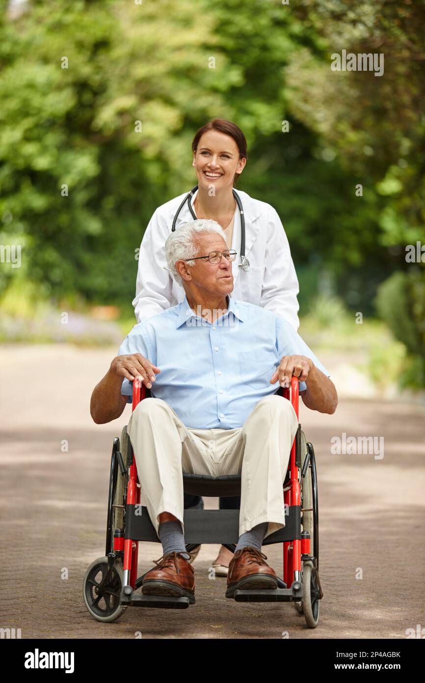 Nice day to be out and about. a female doctor taking her senior patient ...