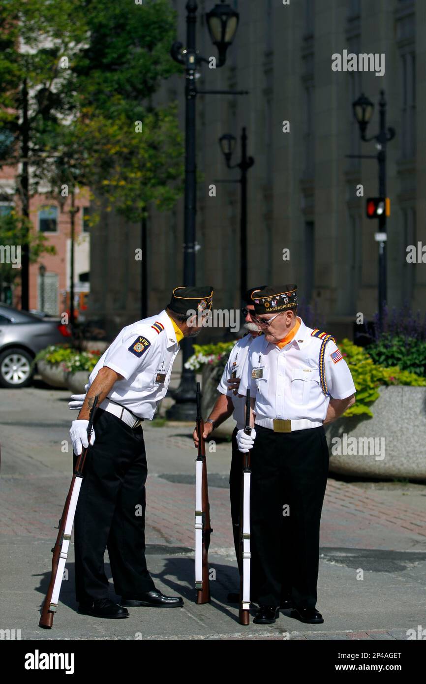 Members of the VFW Rifle Squad talk amongst themselves during a ...