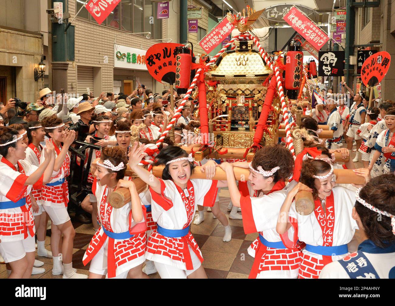 Girls carry a portable shrine during the Gal Mikoshi Parade of the ...