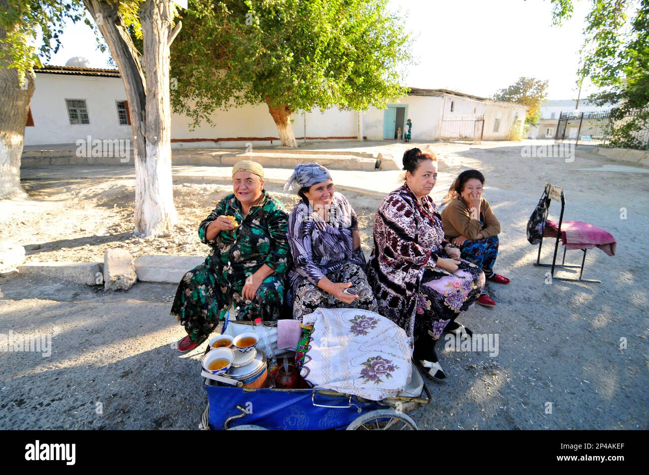 Uzbek women selling tea from an old vintage baby carriage in Bukhara ...