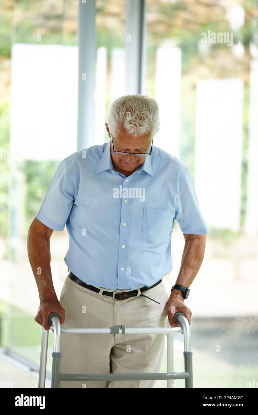 Disability is not inability. a senior man using a walker Stock Photo ...
