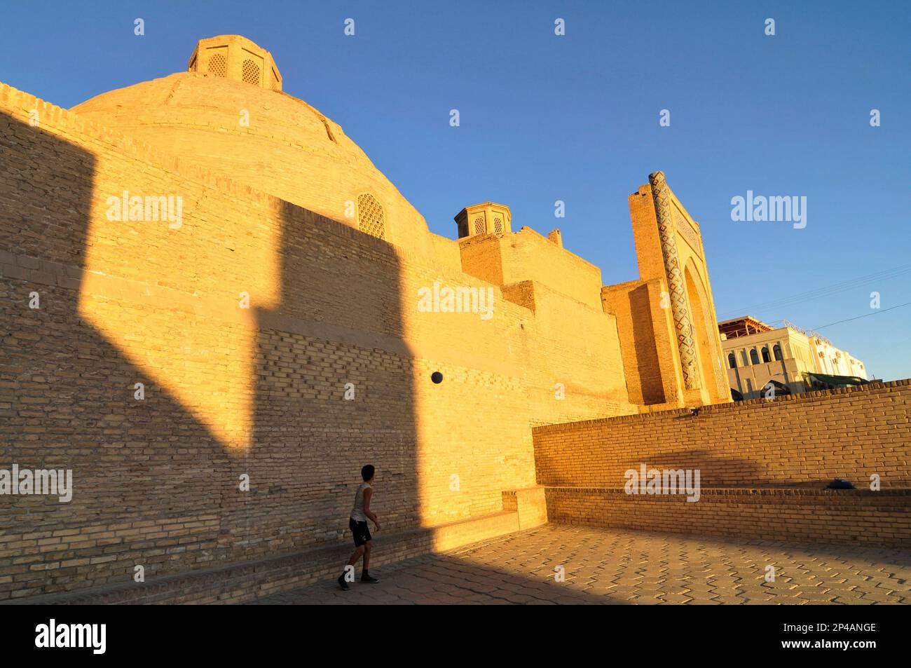 Uzbek boys playing football by the Kalan mosque in the old city of ...