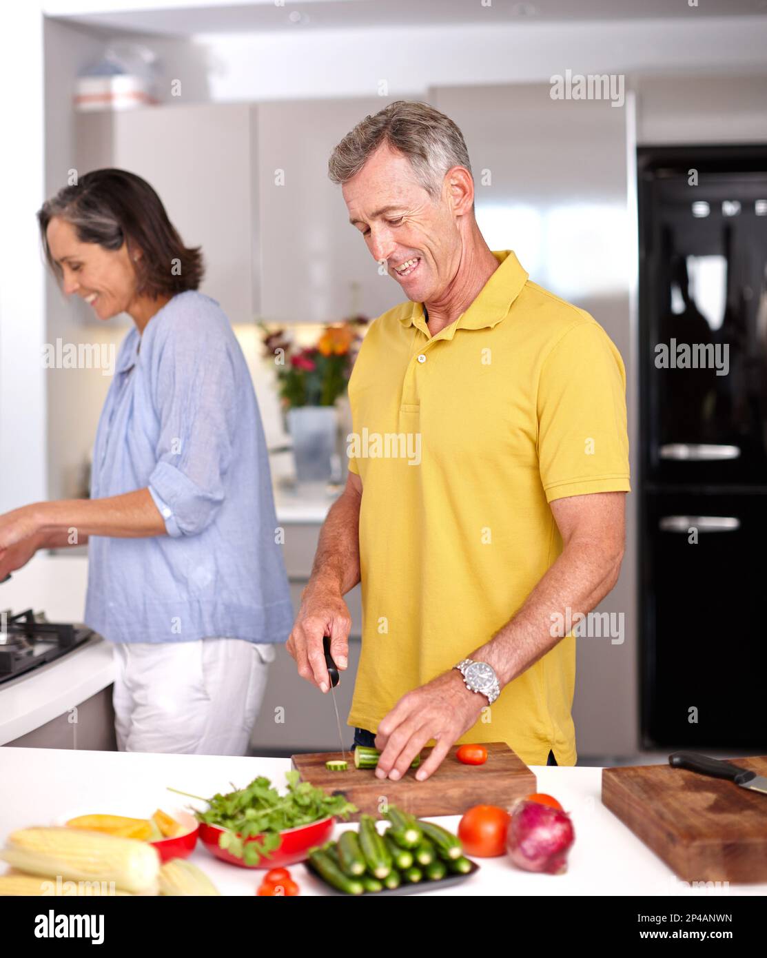 Sharing responsibilities in the kitchen. a mature couple preparing a ...
