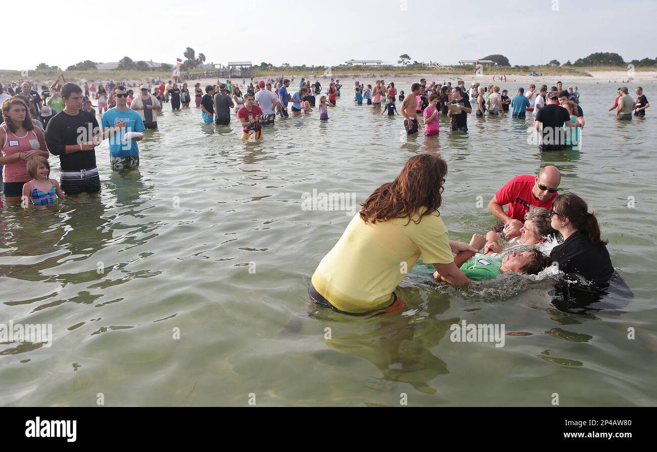 Joe Trzaska and his wife, Kim, are baptized simultaneously during ...