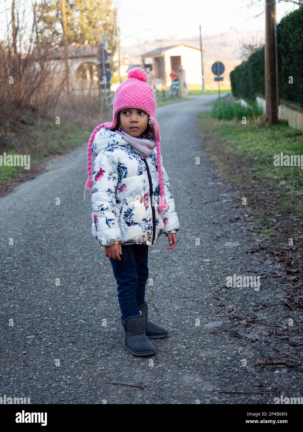 cute thoughtful sad african american baby girl outdoors a cold sunny ...