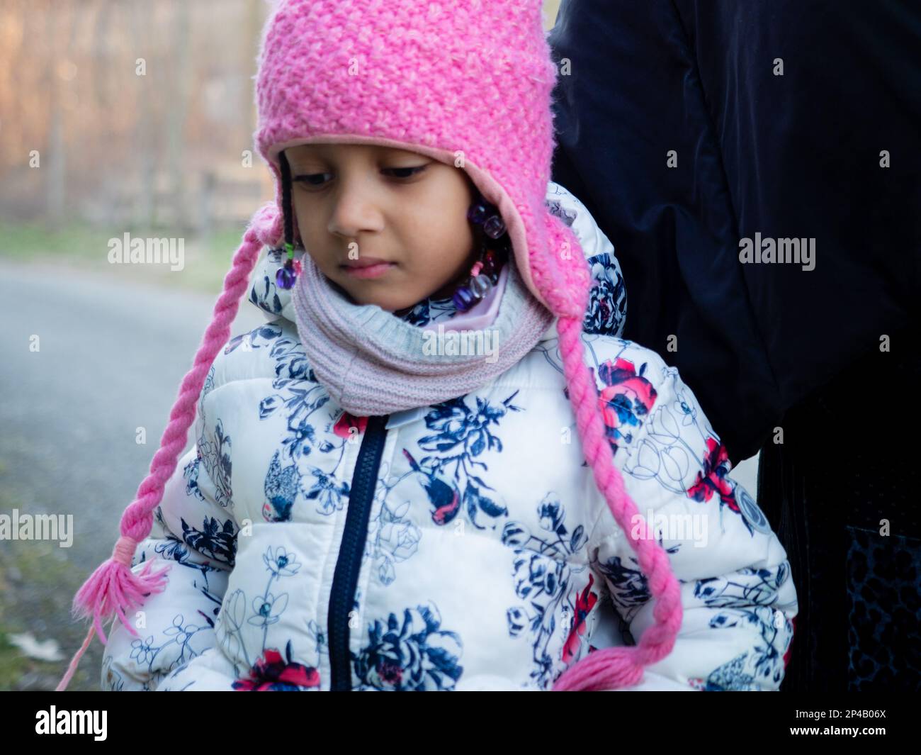 cute thoughtful sad african american baby girl outdoors a cold sunny ...