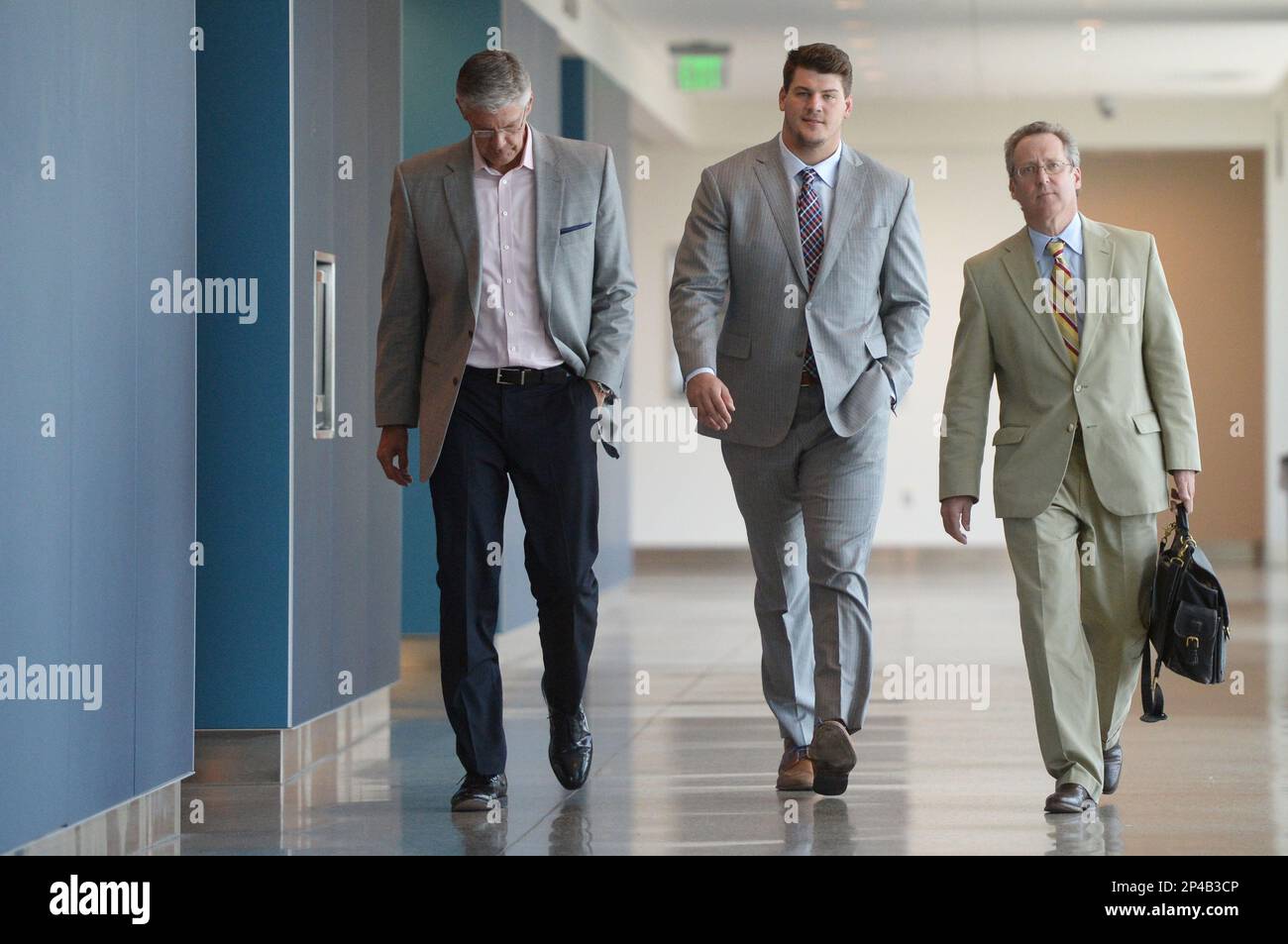 Tennesee Titans NFL football player Taylor Lewan, center, walks into ...