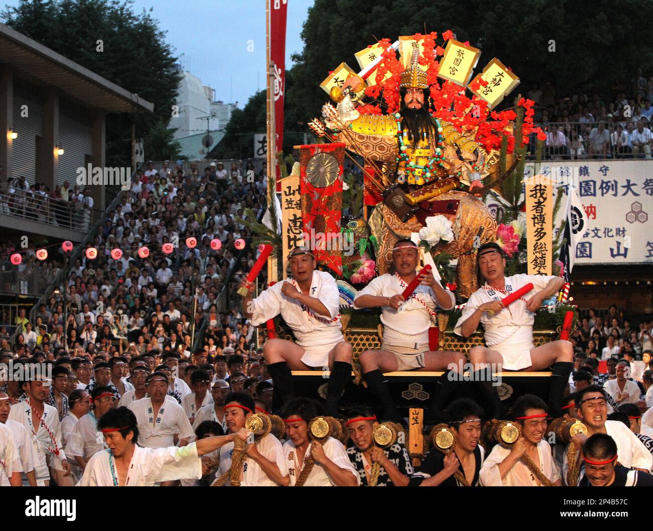 Men carrying 5-ton Yamakasa, floats compete in the middle of Hakata's ...