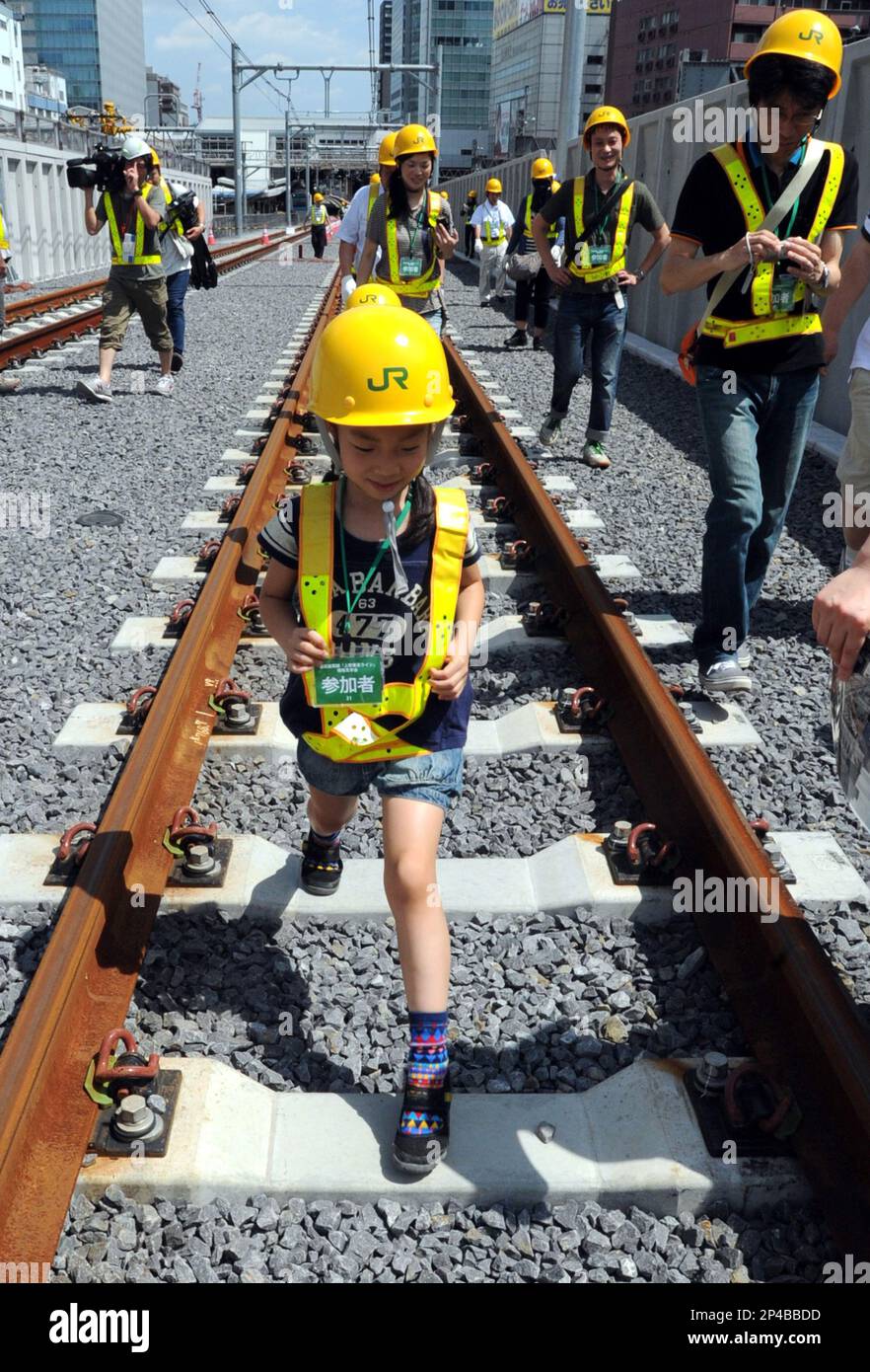 People in Tokyo walk on newly built tracks between Akihabara and Kanda ...