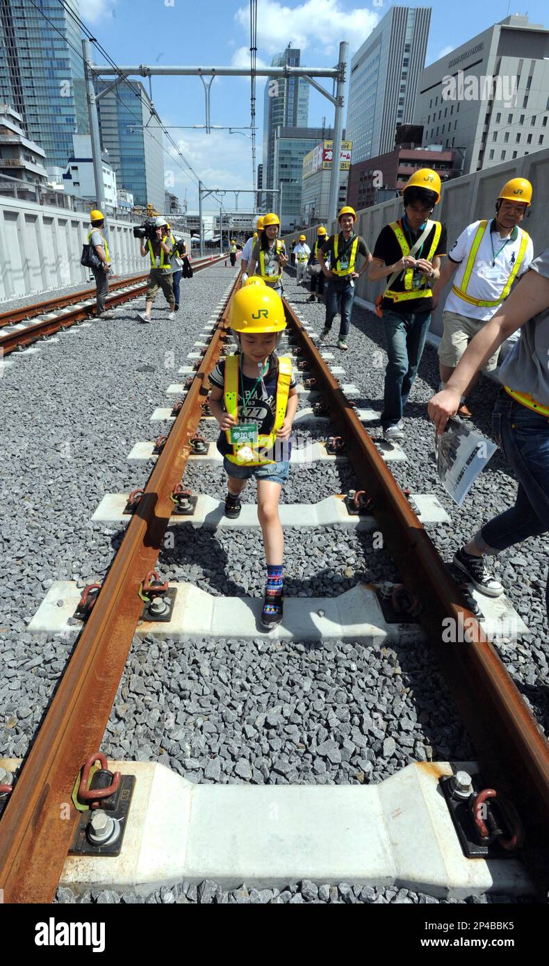 People in Tokyo walk on newly built tracks between Akihabara and Kanda ...