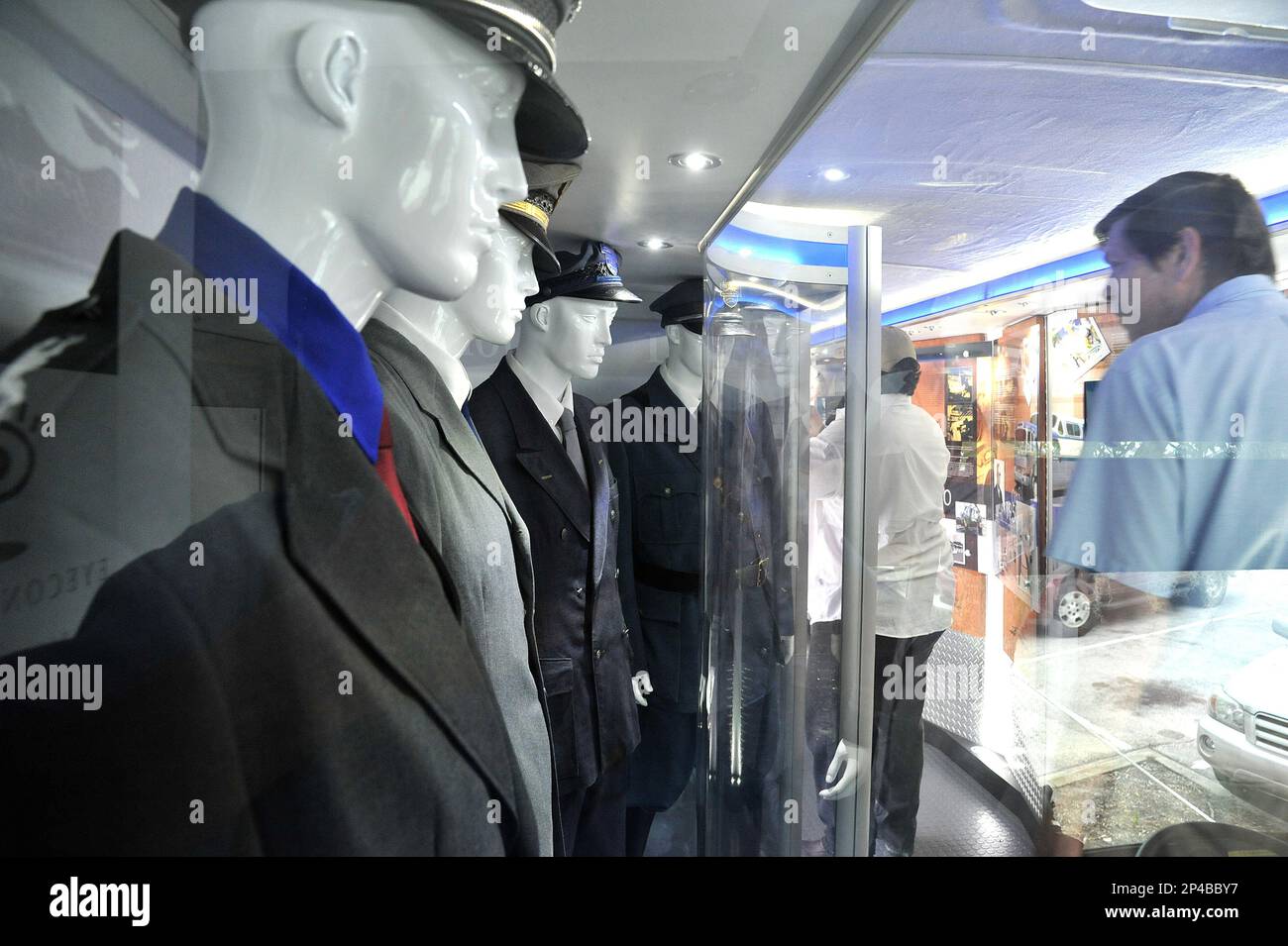 Visitors to the mobile museum view memorabilia, including the evolution ...