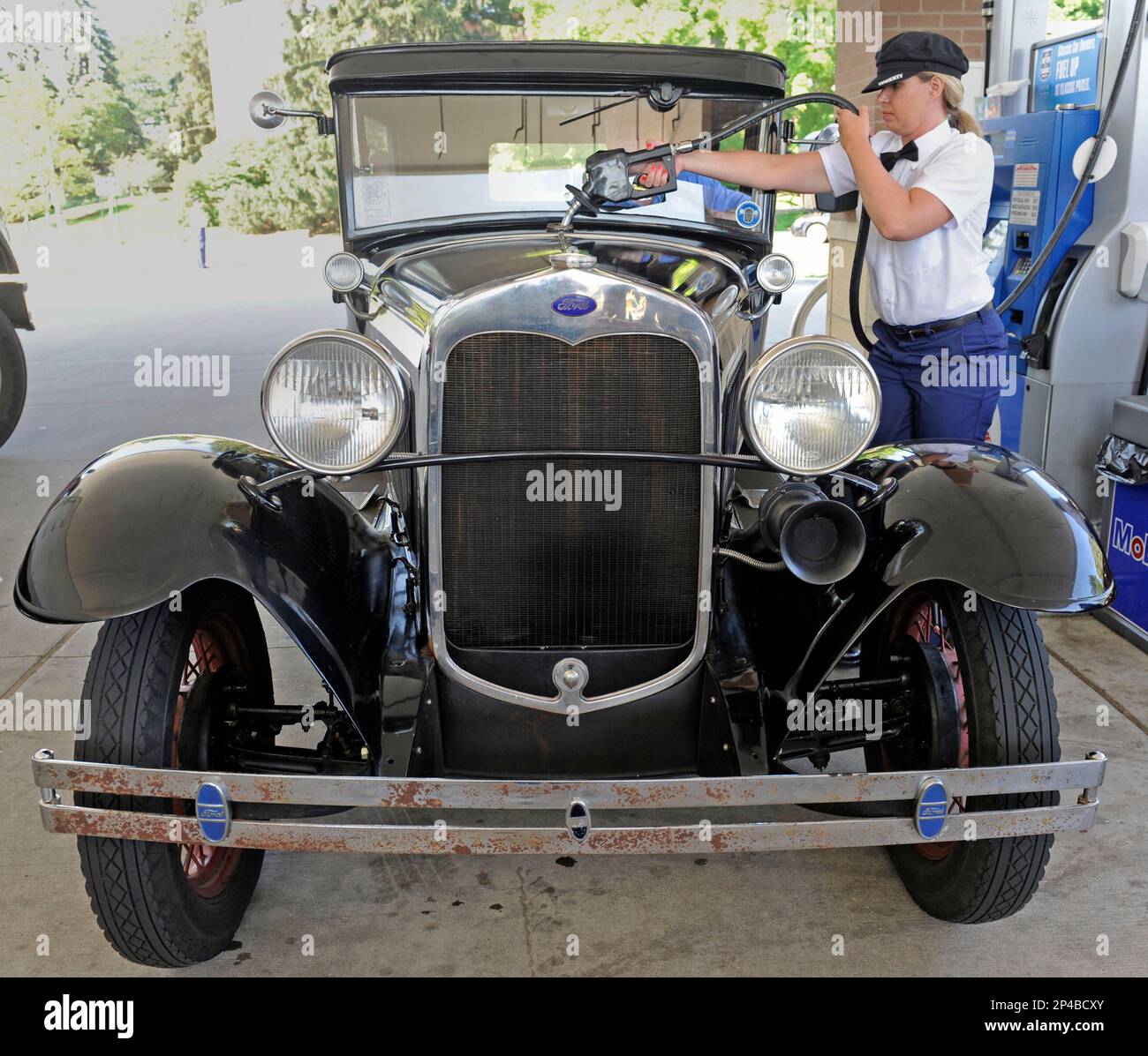 Kory Felker ,37, of Traverse City, fills up a 1930 Ford Model A Tudor ...