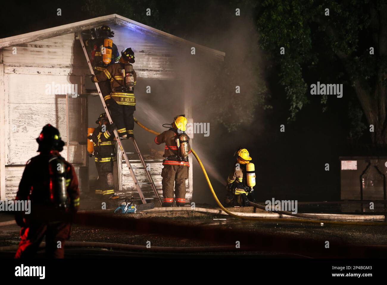 Firefighters work late into the night after a large fire at the ISC ...