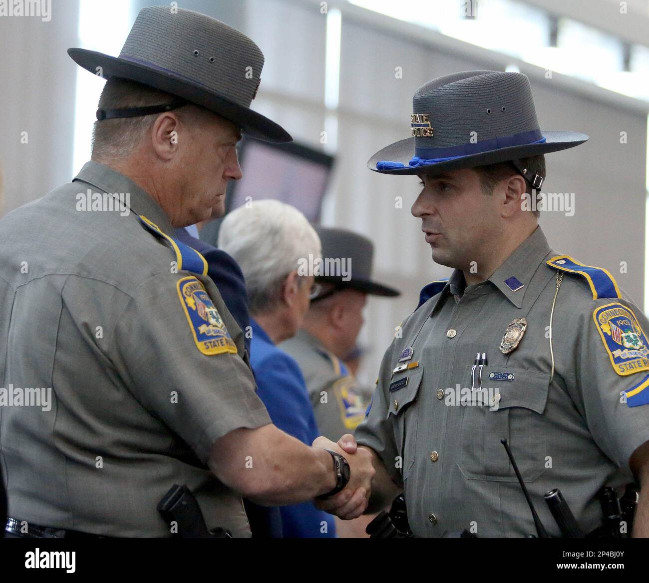 Connecticut State Police Lt. Col. Warren Hyatt, left, shakes detective ...