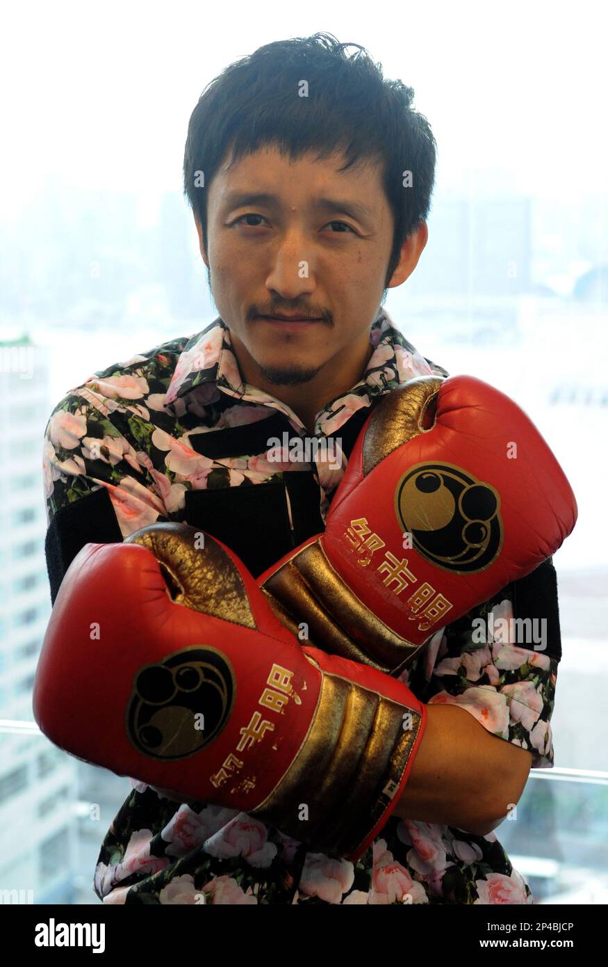 Chinese boxer Zou Shiming poses at an interview ahead of Champions of ...