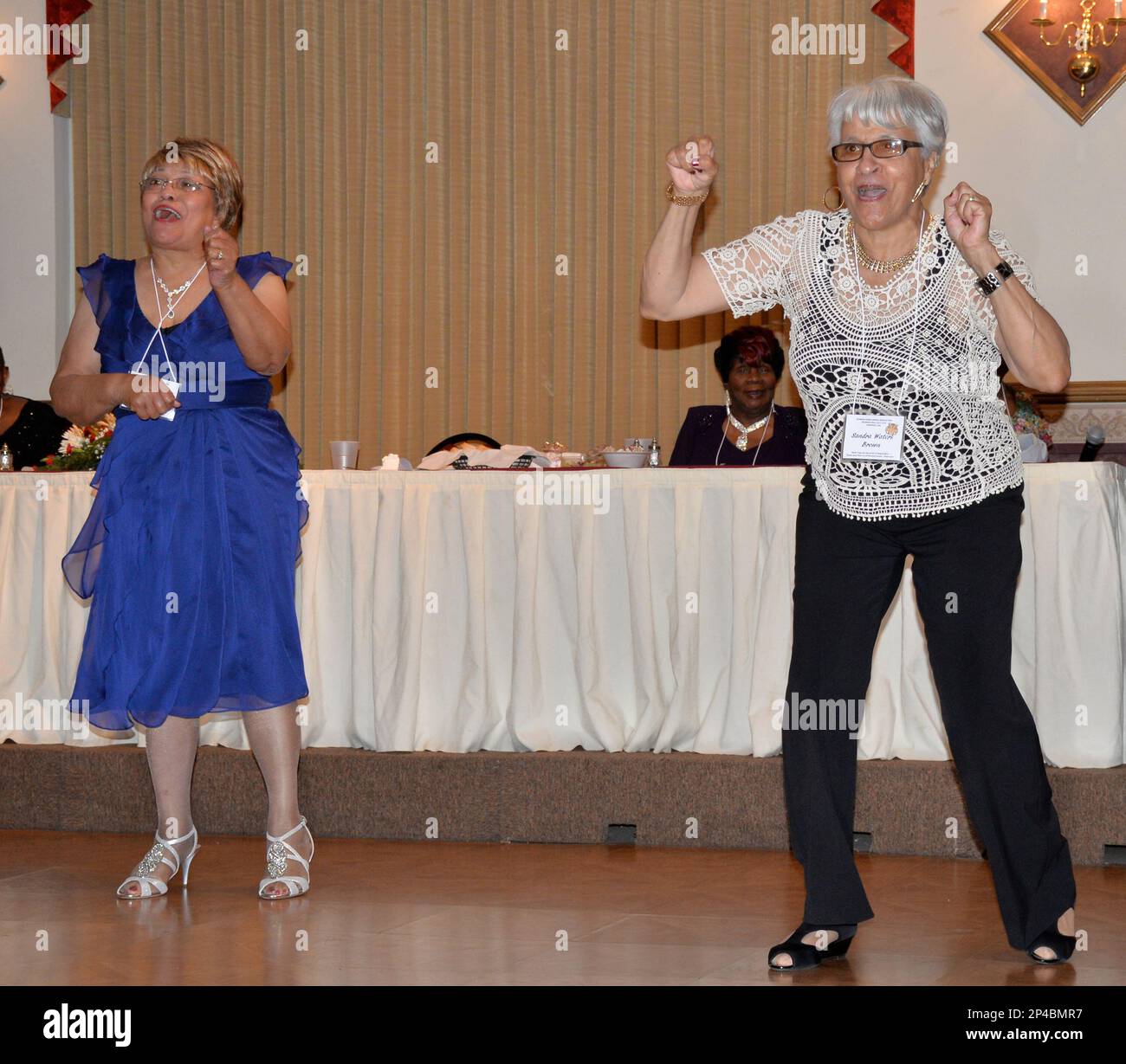 Dunbar Cheerleaders Evelyn Tucker and Sandra Brown lead the Alumni in a ...