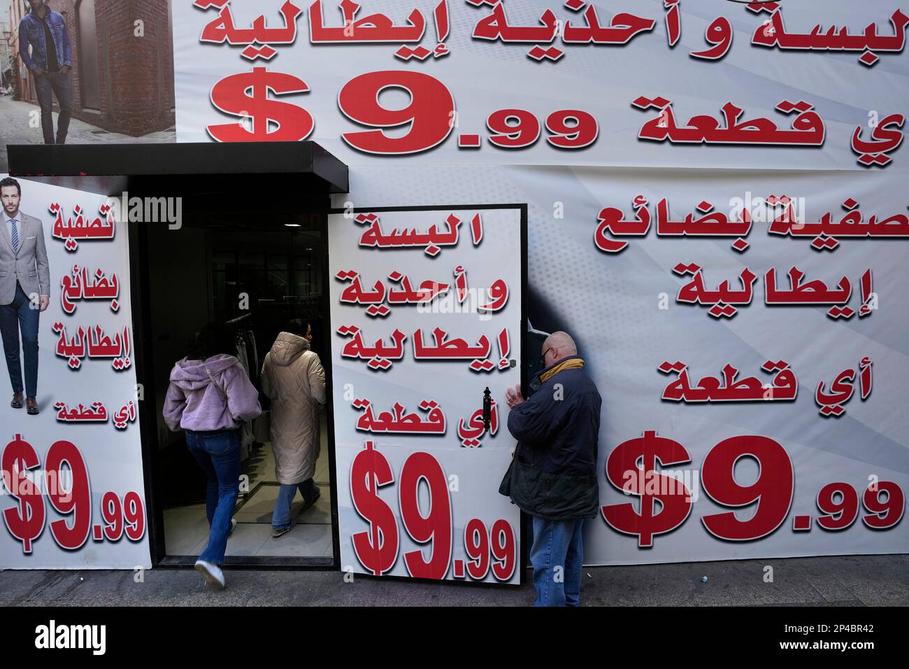 Store displays advertising in Arabic that reads "Italian clothes and ...