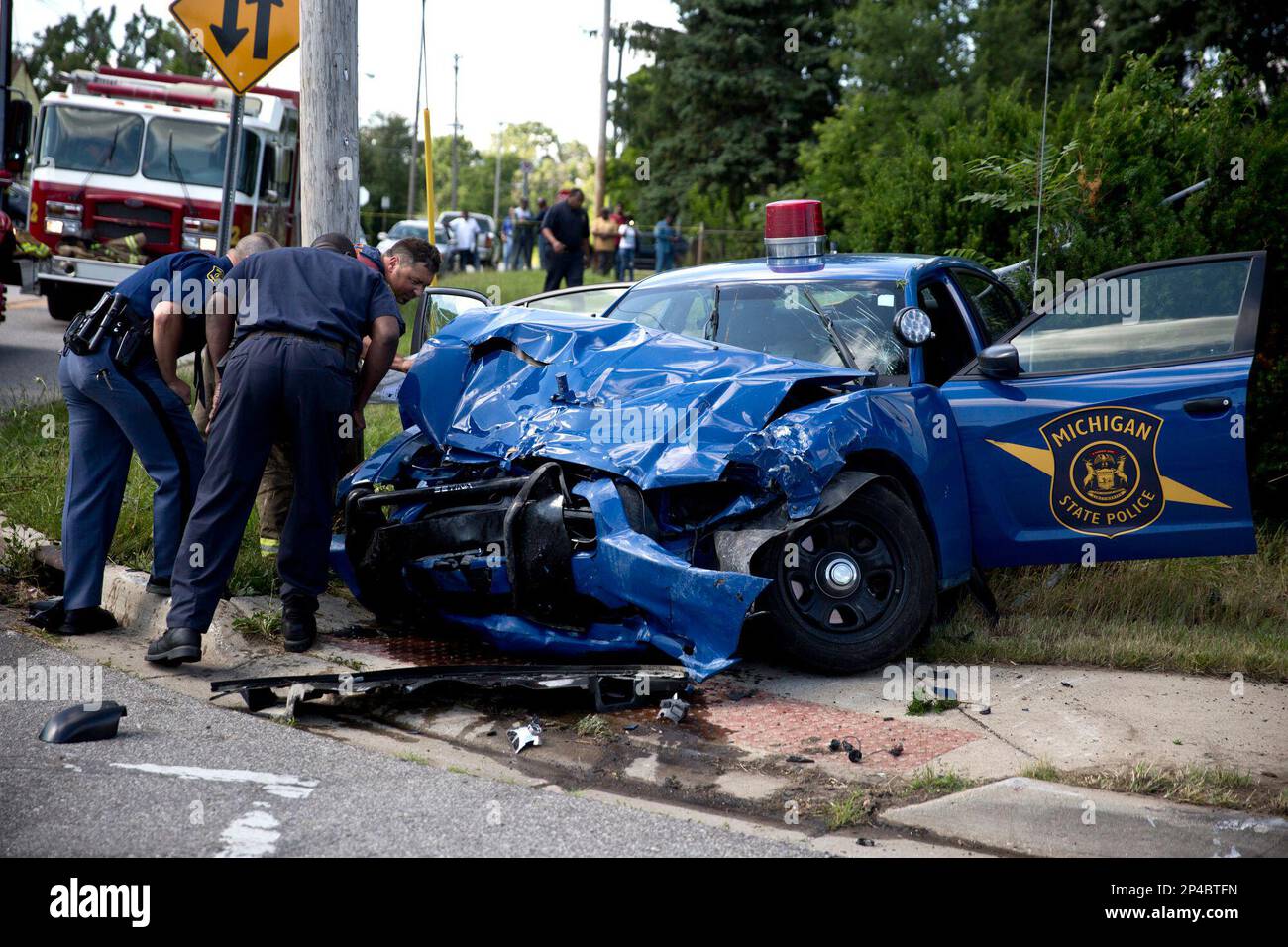 Michigan State Police inspect the wreckage of a Michigan State Police ...