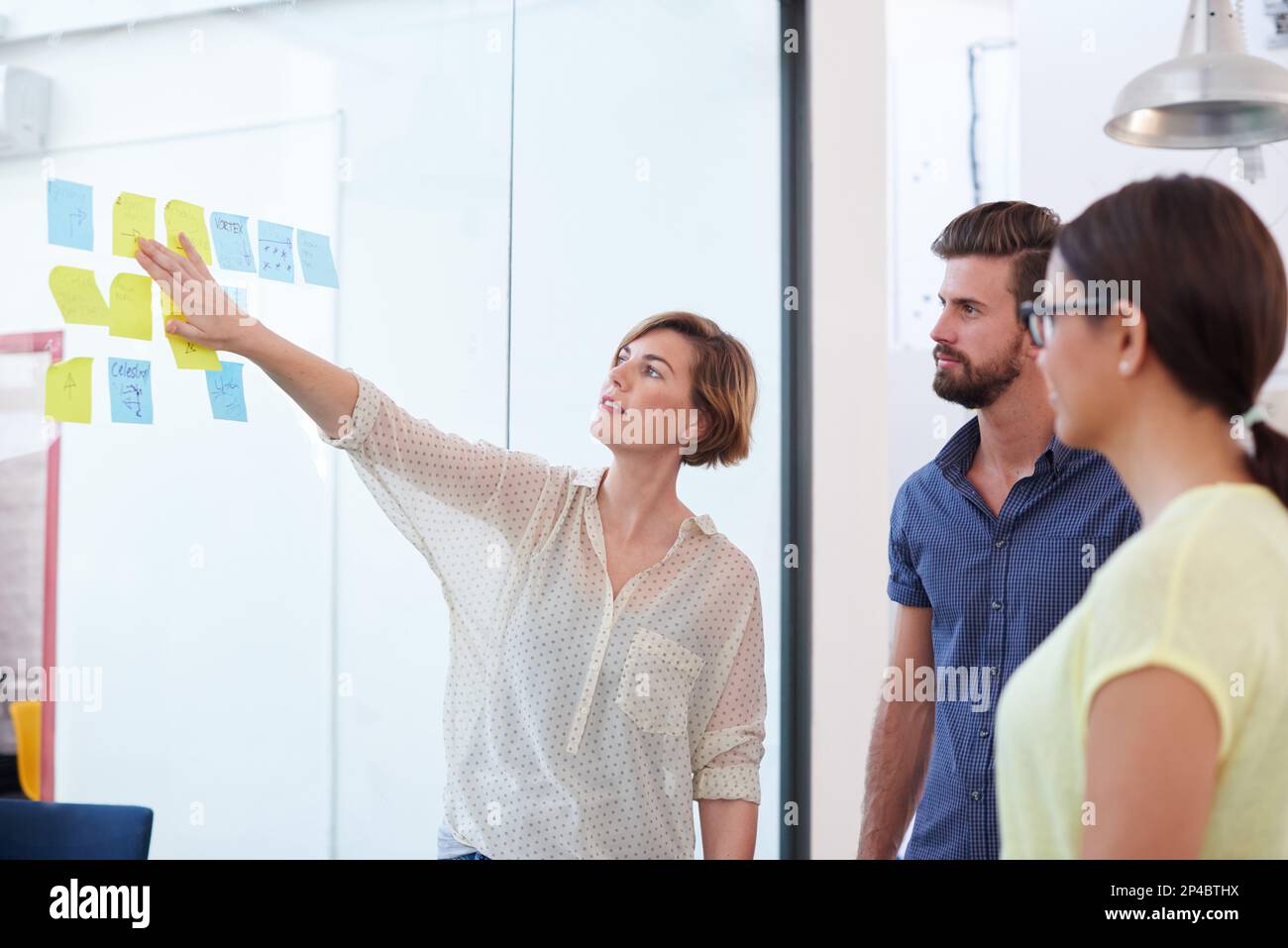 Giving her ideas a voice. a group of colleagues discussing ideas ...