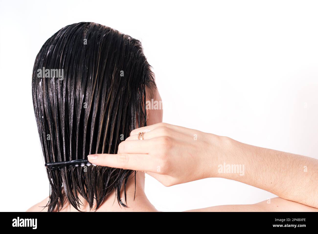 Lady with comb combs her hair in balm against white background Stock ...
