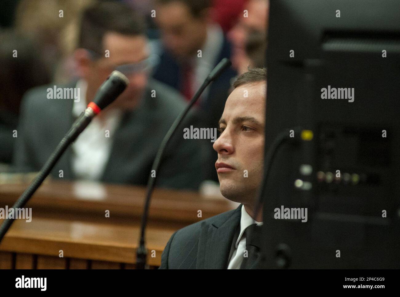 Oscar Pistorius listens to evidence in a courtroom in Pretoria, South ...