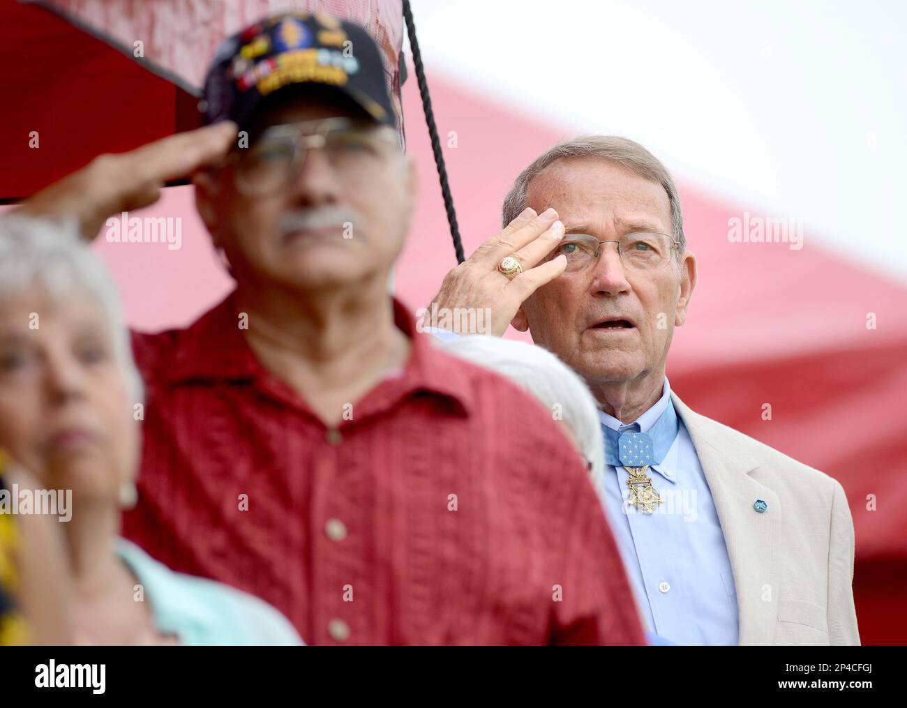 Retired U.S. Army Col. Roger Donlon salutes the flag during the singing ...