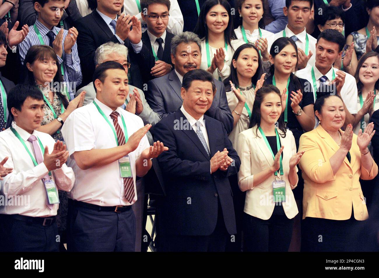 Chinese President Xi Jinping claps hands as he poses for a group photo ...