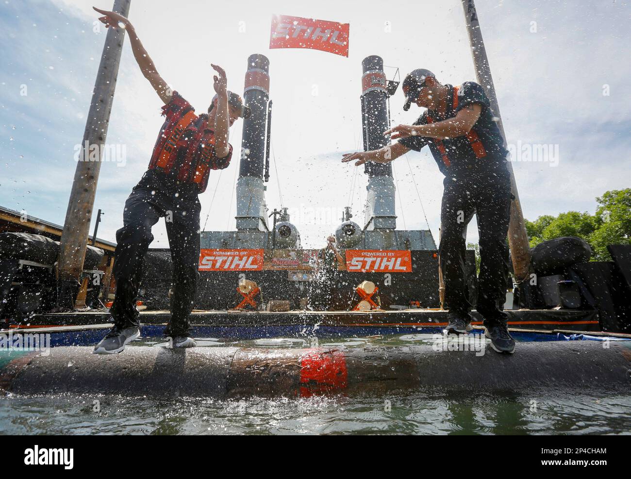 Brodie Orton, left, and Brian Kilian compete in a log-rolling contest ...