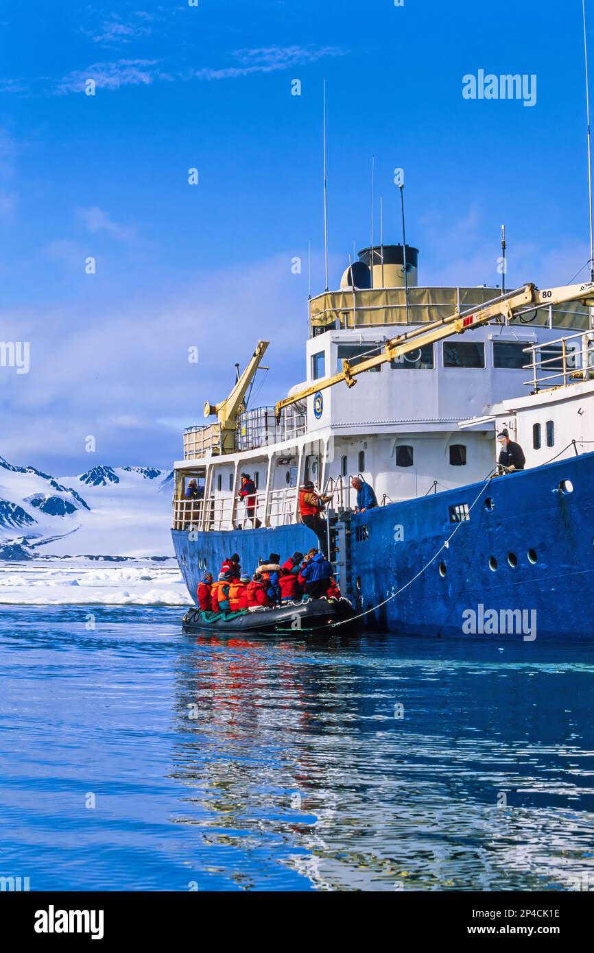 People climbing aboard a boat Stock Photo - Alamy