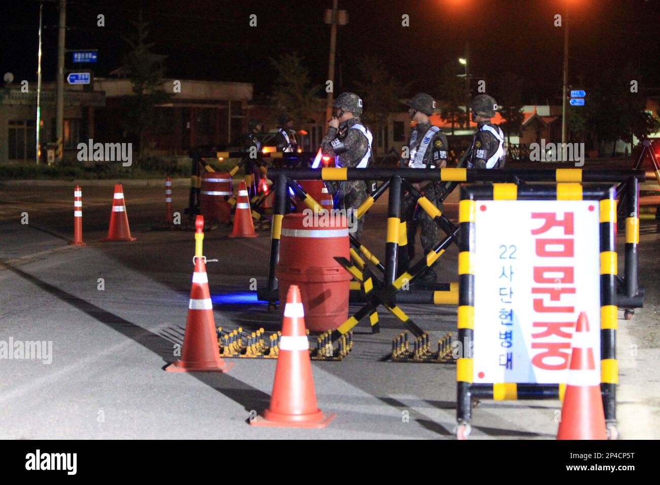 South Korean army soldiers stand guard at a temporary checkpoint in ...