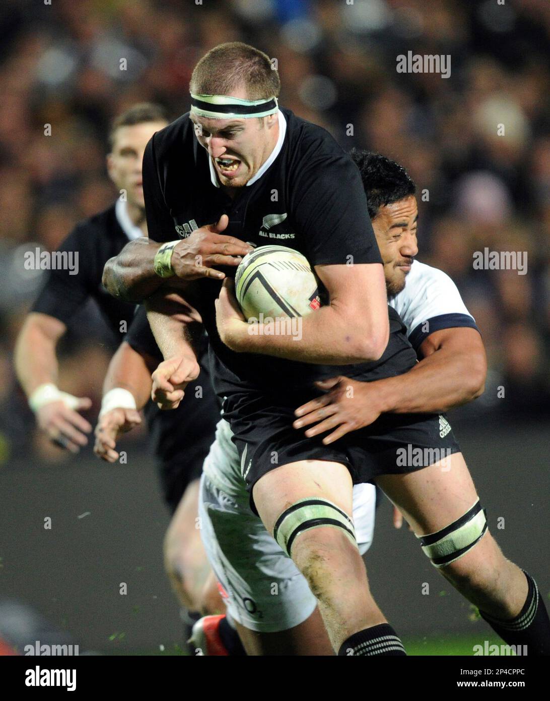 New Zealand’s Brodie Retallick is tackled by England’s Mana Tulagi ...