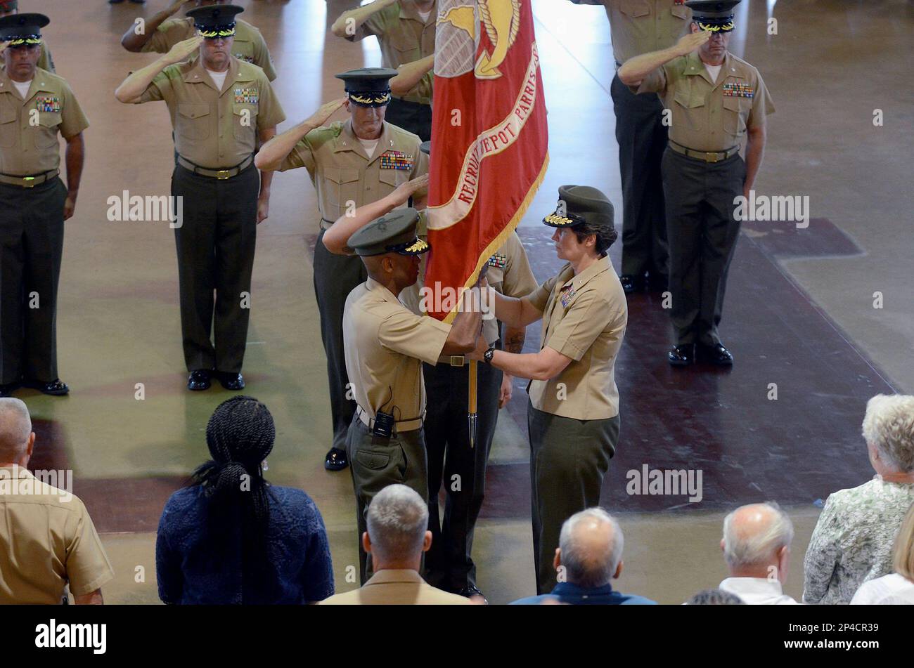 Brig. Gen. Lori Reynolds, right, hands the Marine Corps colors ...
