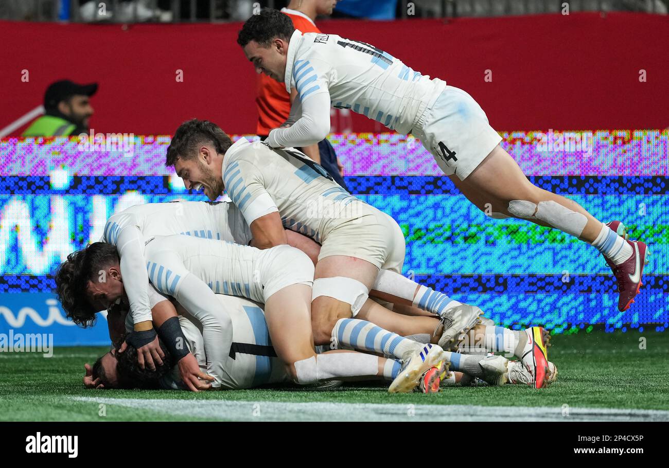 Teammates pile on top of Argentina's Agustin Fraga, bottom back left ...