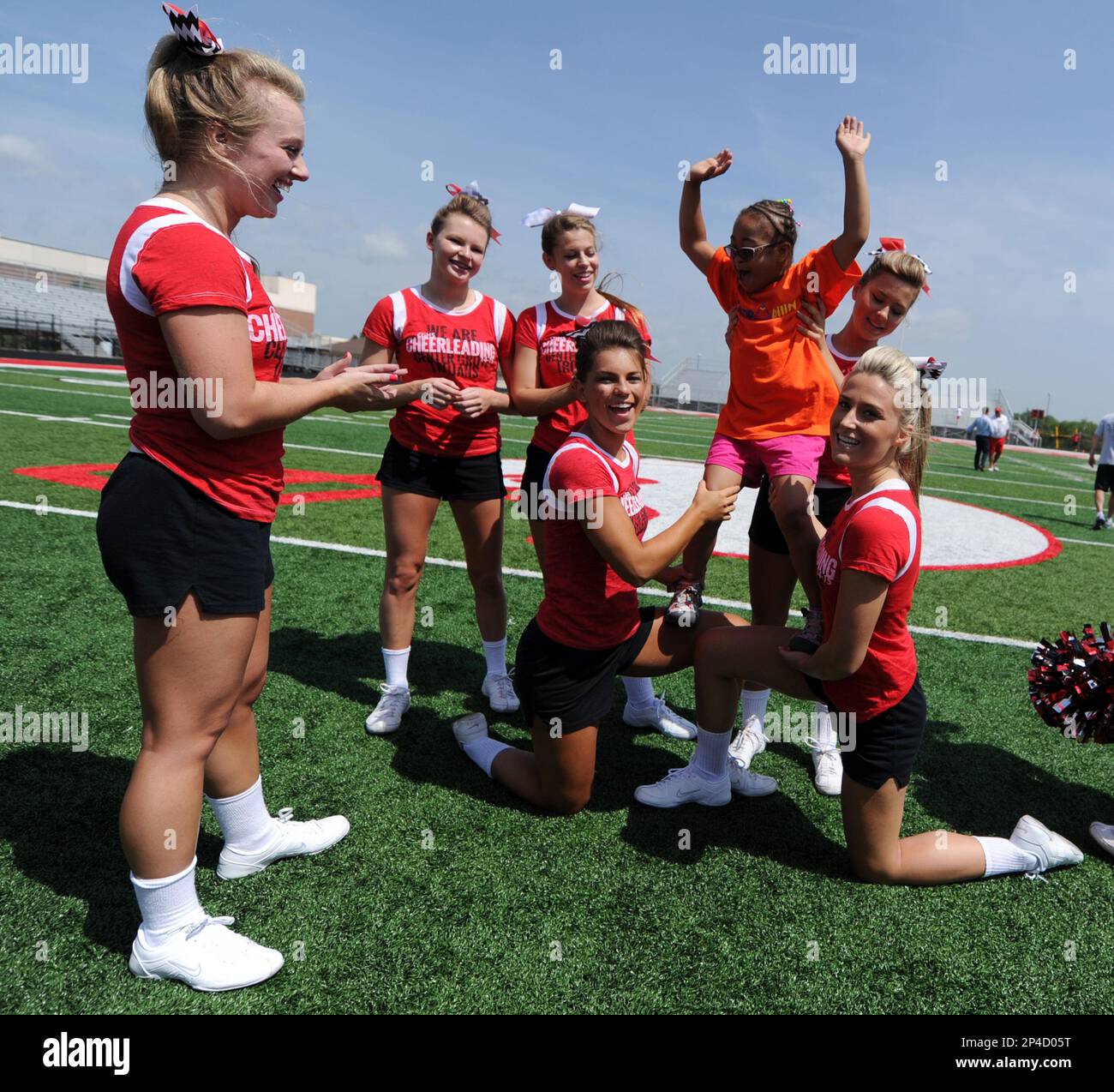 Zoe Neal-Gibson gets lifted up by Center Grove cheerleaders at a ...