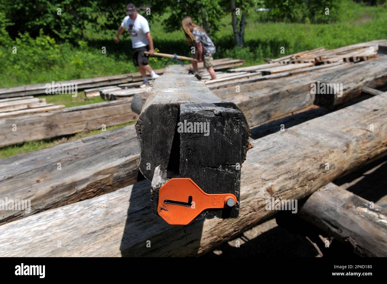 Curt Richter, left, and his son Noah place timbers salvaged from a log ...