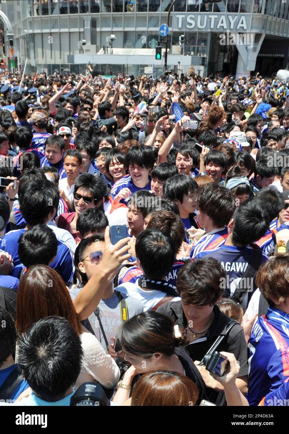 Supporters of Japanese national squad, Samurai Blue cheer at a scramble ...