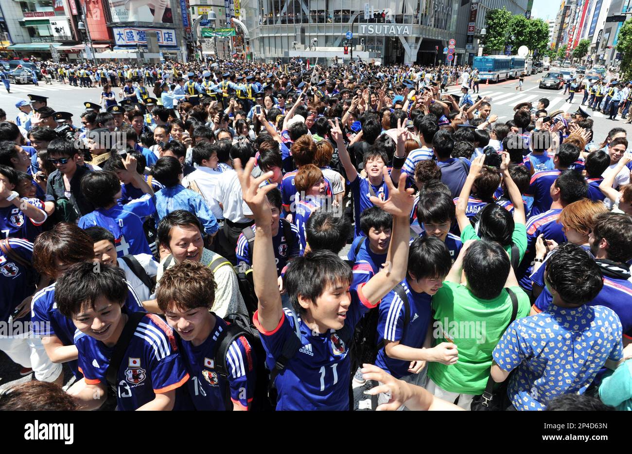 Supporters of Japanese national squad, Samurai Blue cheer at a scramble ...