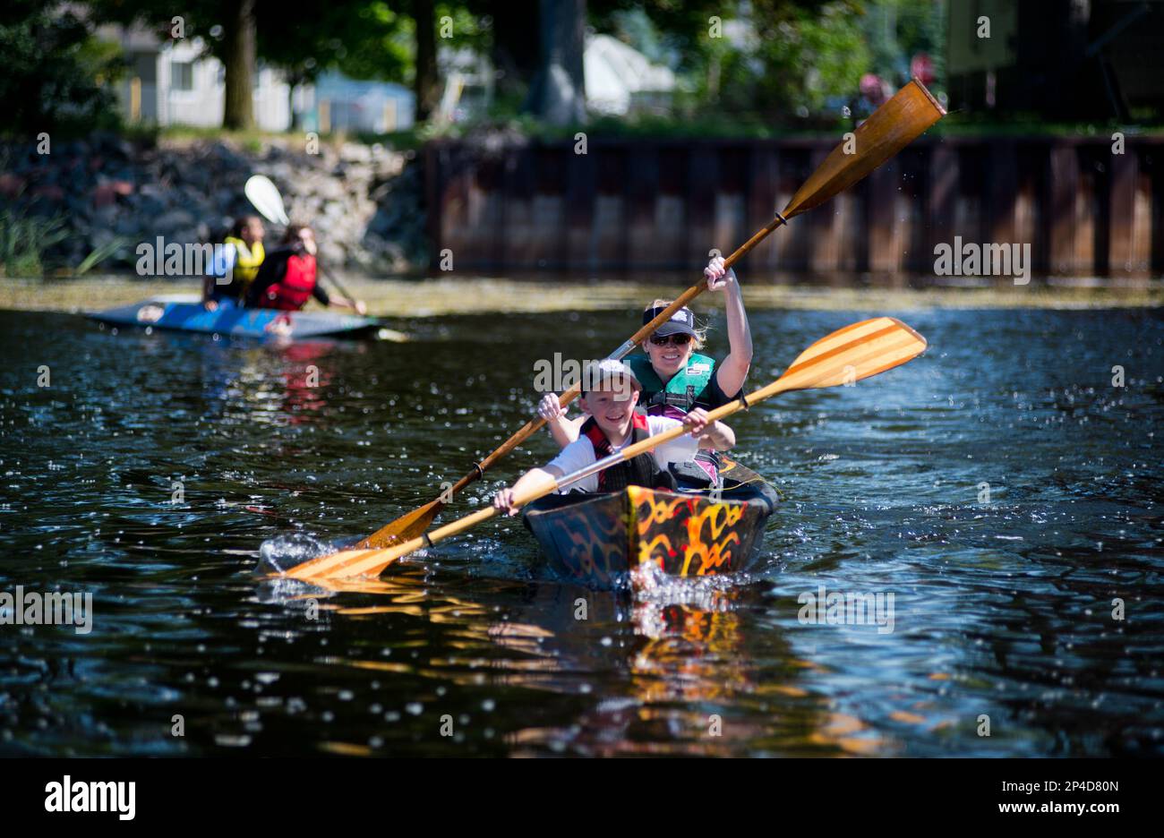 Amy Mueller and Justin Mueller, 9, paddle "Kid n' Me" to dock during ...