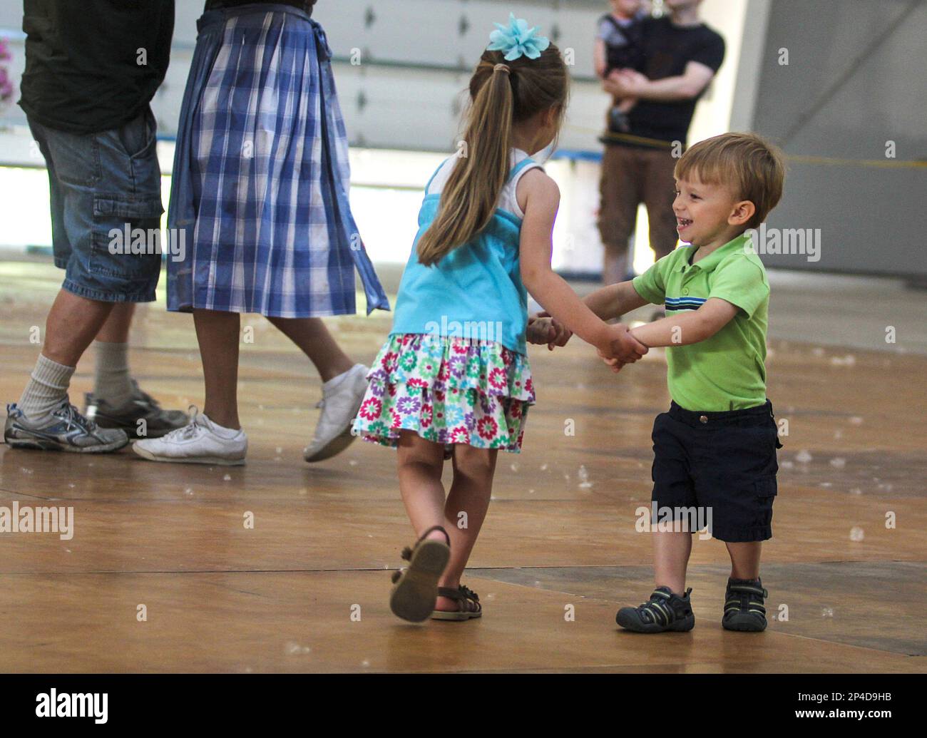 Eva Hecht, 4, dances with her younger brother Nathan Hecht, 1, during ...